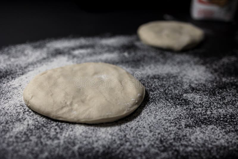 Dough of Round Shape on a Black Table. Stock Photo - Image of culinary ...