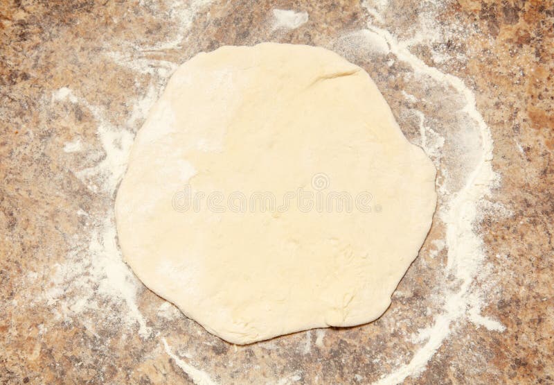 A Doughnut is Being Rolled Out on a Counter Stock Image - Image of ...