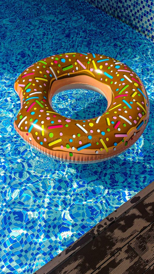 A Doughnut in a Swimming Pool Stock Image - Image of flower, blue ...