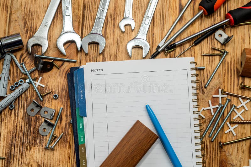 Dowel Screws and Keys are Scattered on the Table Next To a Folder and a ...