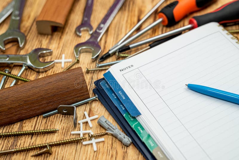Dowel Screws and Keys are Scattered on the Table Next To a Folder and a ...