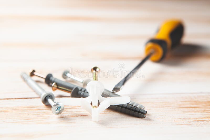 Dowels and Screwdriver on the Table Stock Photo - Image of improvement ...