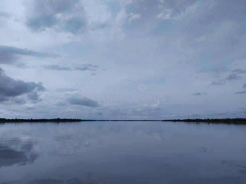 Down the River with Shadows in the Water and Clouds Above in the Blue ...