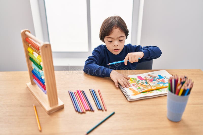 Down Syndrome Kid Drawing on Notebook at School Stock Image - Image of ...