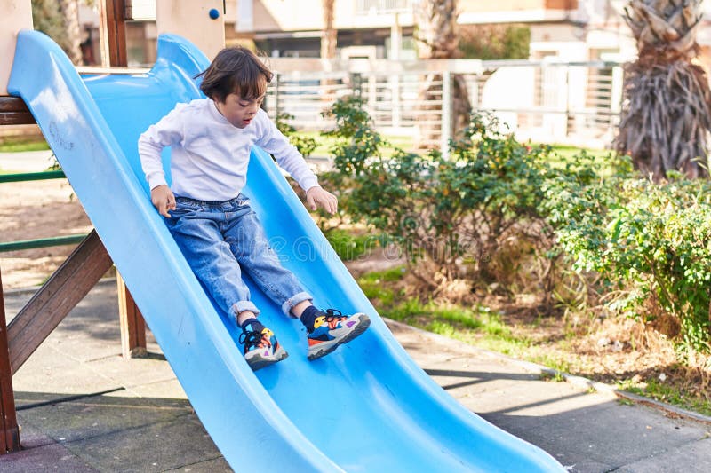 Down Syndrome Kid Playing on Slide at Park Stock Image - Image of play ...