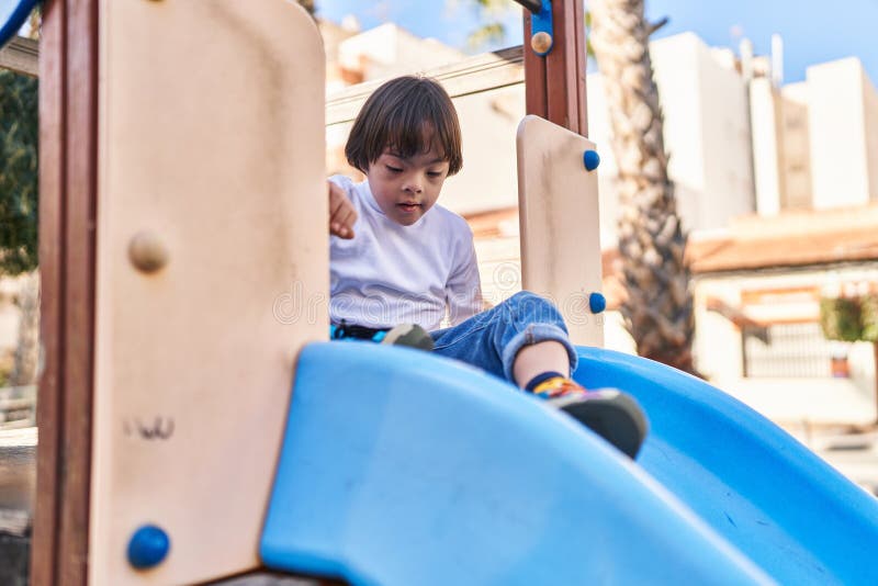 Down Syndrome Kid Playing on Slide at Park Stock Photo - Image of child ...
