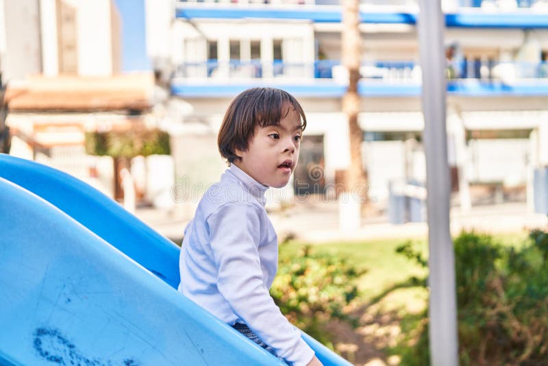 Down Syndrome Kid Playing on Slide at Park Stock Image - Image of ...