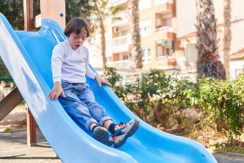 Down Syndrome Kid Playing on Slide at Park Stock Photo - Image of sunny ...