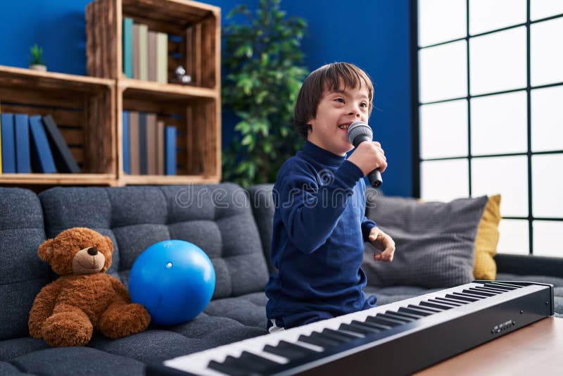 Down Syndrome Kid Singing Song Sitting on Sofa at Home Stock Image ...