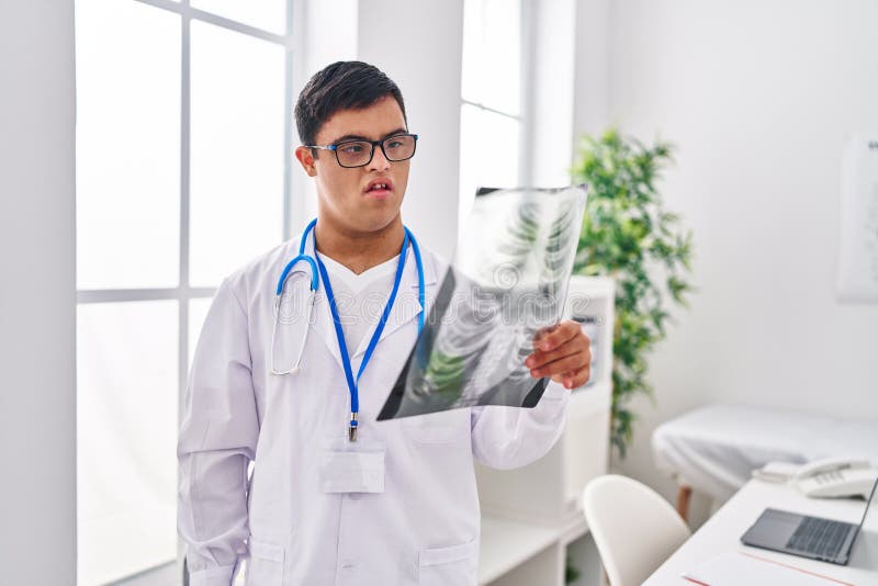 Down Syndrome Man Wearing Doctor Uniform Holding Xray at Clinic Stock ...