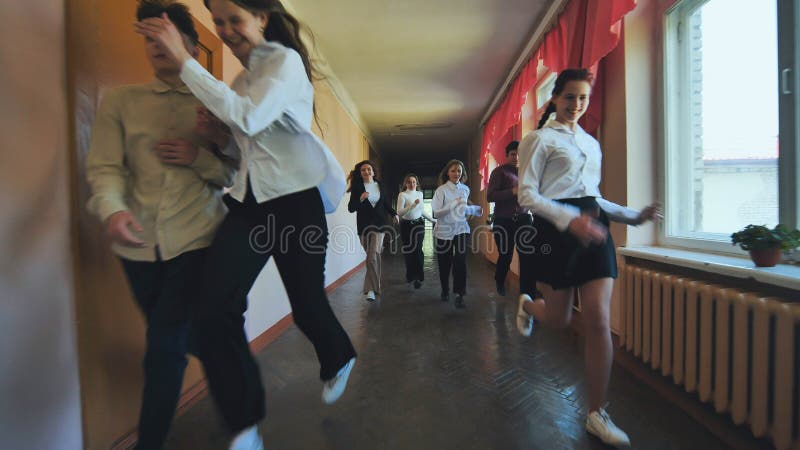 A Down-syndrome School Boy with Group of Children in Corridor, Running ...