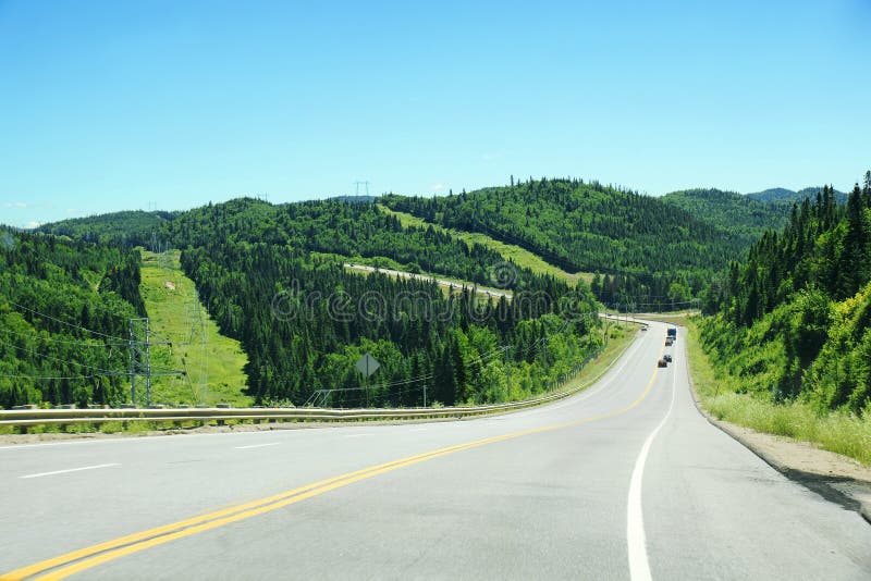 Downhill Road with Mountains and Coniferous Trees Stock Image - Image ... Downhill Road with Mountains and Coniferous Trees Stock Image - Image ...