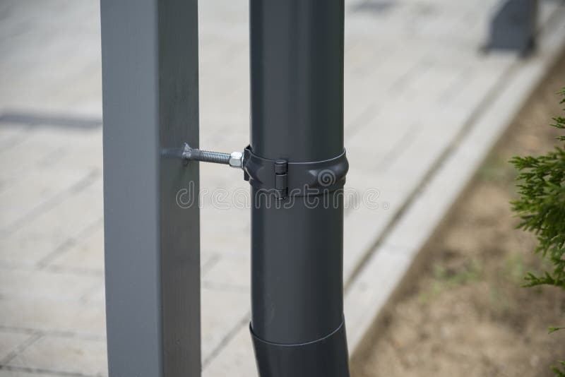 Downspout Bracket and Pipe Welded on a Post Stock Image - Image of ...