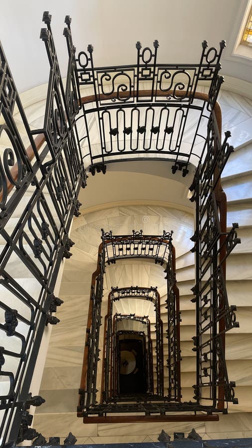 Downward View of Elegant Spiral Stairs with Classic Black Iron Railing ...
