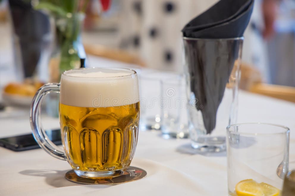 Draft Beer in a Glass on a Glass Stand on a Festive Table Stock Image ...