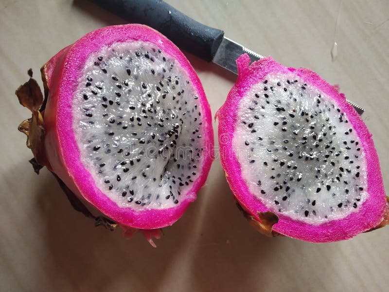 Dragon Fruit Cut into Two Piece Stock Image - Image of hand, piece ...