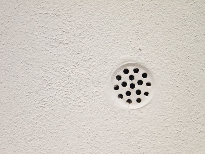 Drain cap on a white wall stock image. Image of grating - 61051877