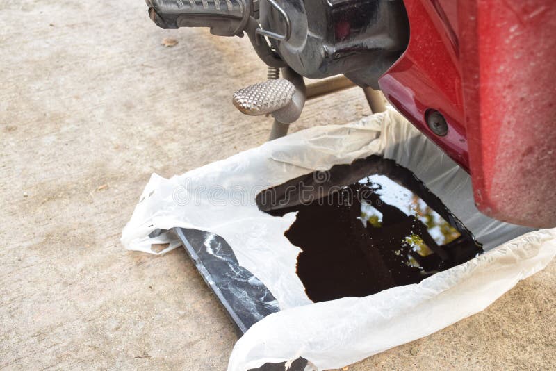 Drain the Old Oil from the Engine through the Drain Plug. Changing the ...