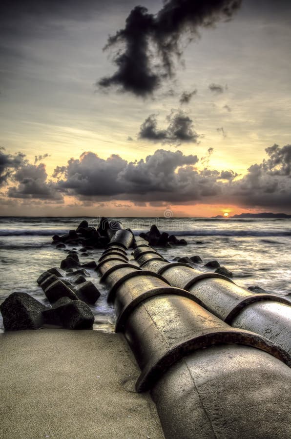 Drain Pipe on the Coast. Waves and Dramatic Cloud during the Sunset ...