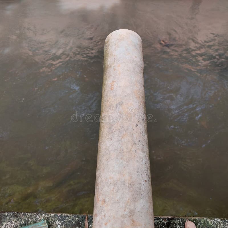 Drain pipe to the river stock image. Image of drain - 261512757