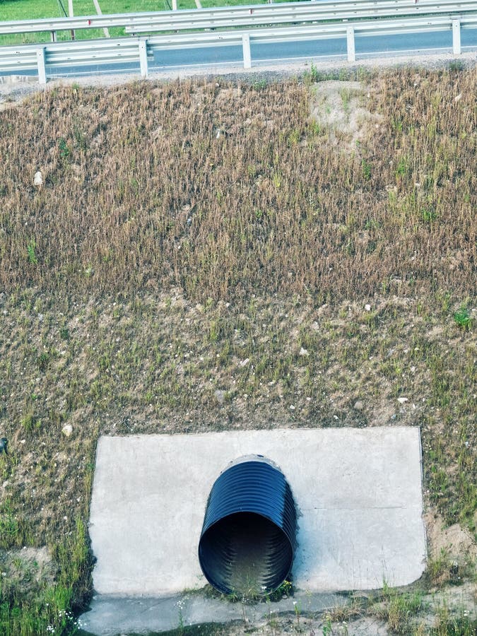 Drain On The Road To Prevent Flooding On The Road. A Manhole Cover In ...