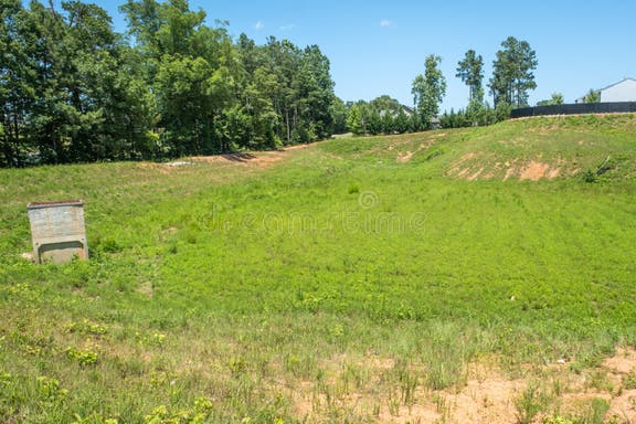 Drainage Ditch Lined with Grass and Weeds Behind a Subdivision Stock ...