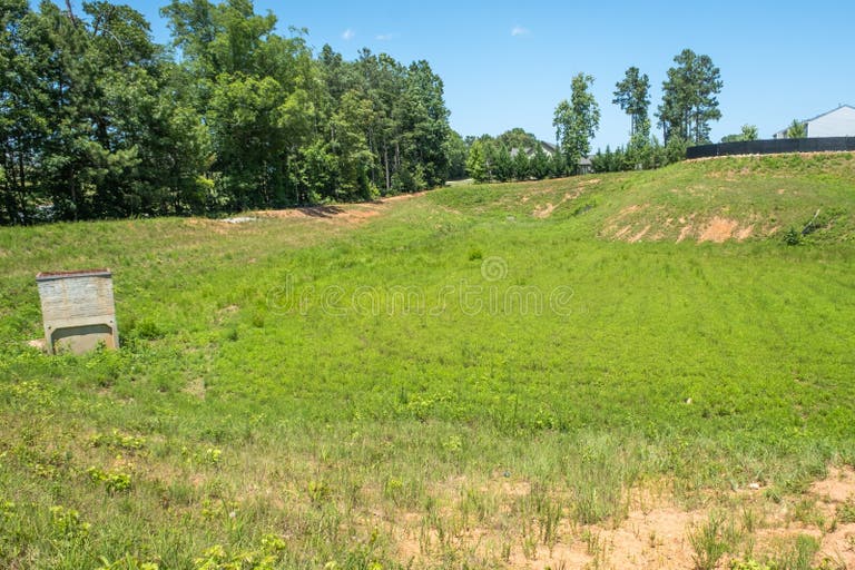 Drainage Ditch Lined with Grass and Weeds Behind a Subdivision Stock ...