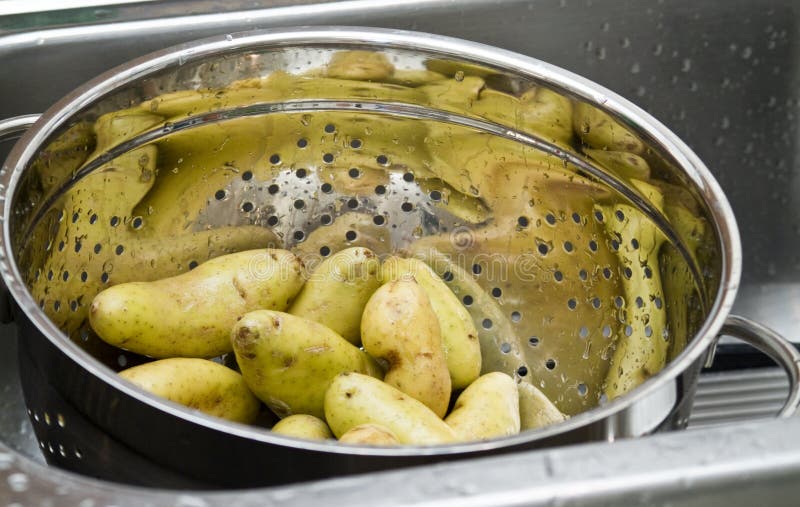Draining the Potatoes stock photo. Image of container - 5140688