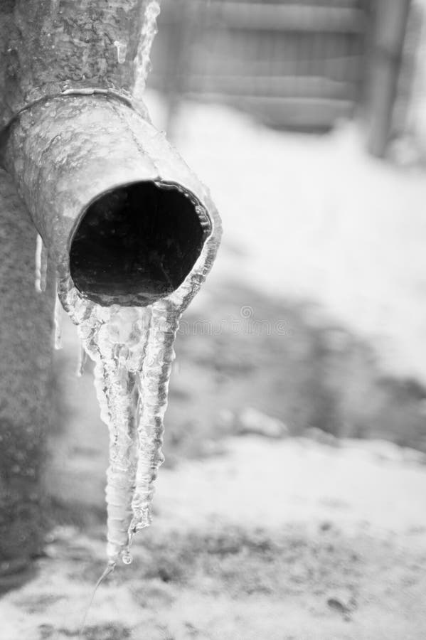 Drainpipe on the Corner of the House Covered with a Thick Layer of Ice ...