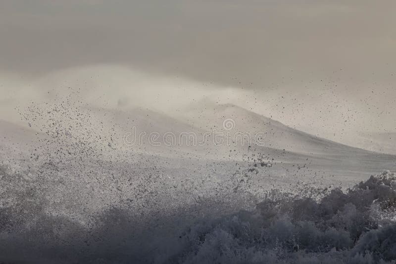Dramatic Beach Scene at Sunset Featuring Turbulent Waves Crashing ...