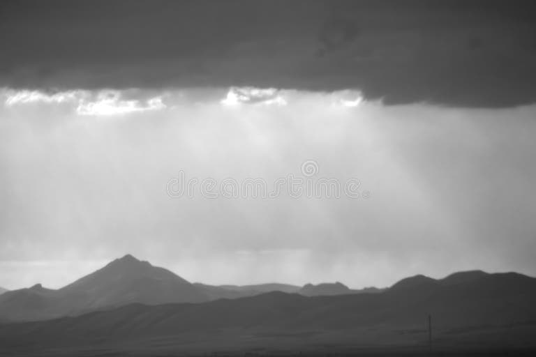 Sunlight Breaking through Clouds Over a Mountain Range, Perfect for Backgrounds Stock Photo ...
