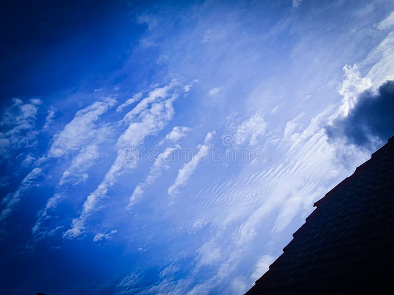 Dramatic Blue Sky with Dynamic Cloudscape and Building Silhouette Stock ...
