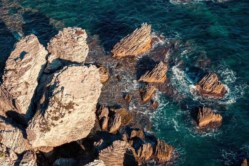 Dramatic Cliff with the Backdrop of a Beautiful Ocean Stock Photo ...