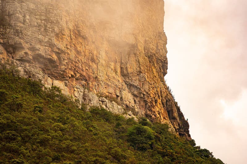 Dramatic Cliff Face with Lush Greenery and Mist. Stock Image - Image of ...