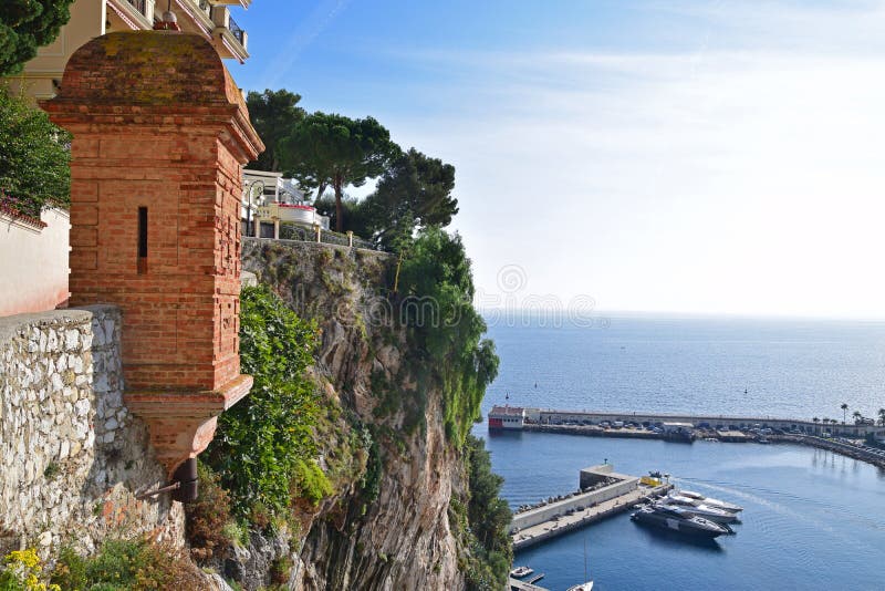 A Dramatic Cliff with Green Trees & Brick Structure and Harbour View of ...
