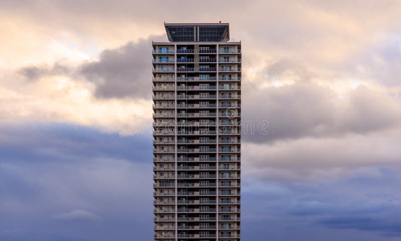 Dramatic Clouds Behind Apartment Tower at Sunset Stock Image - Image of ...