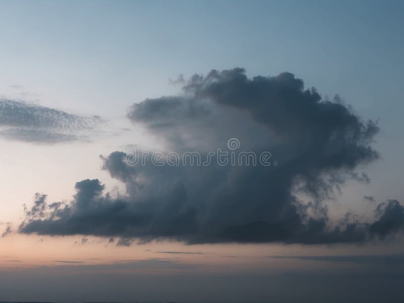 Dramatic Clouds Billow during Twilight Over the Landscape with Shades ...