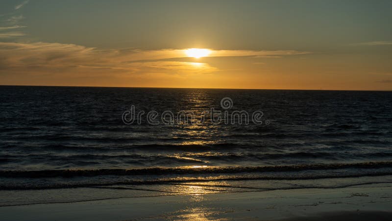 Clear sunset at the beach stock photo. Image of coast - 287997878