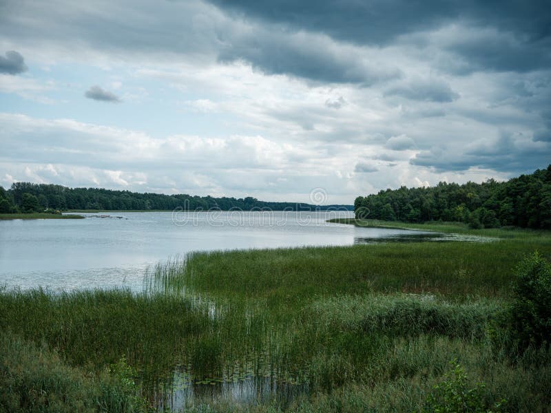 Dramatic Clouds Over Blue Lake Stock Photo - Image of lake, phenomenon ...