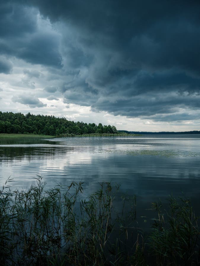 Dramatic Clouds Over Blue Lake Stock Photo - Image of lacustrine, dark ...