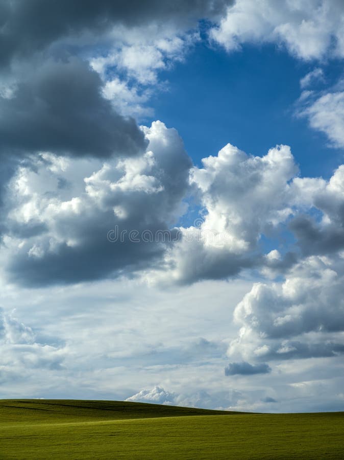 Dramatic Clouds Over a Green Field Stock Photo - Image of storm, season ...