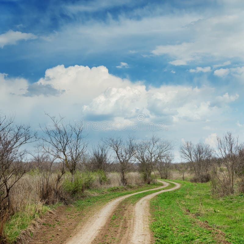 Winding Rural Road Under Cloudy Sky Stock Image - Image of perspective ...