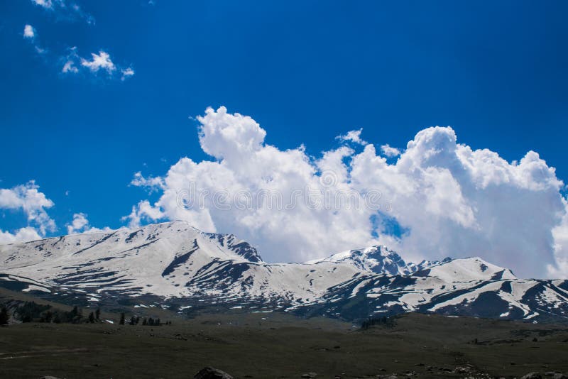 Snow Laden Himalayan Mountains with Clouds Over it. Stock Image - Image ...