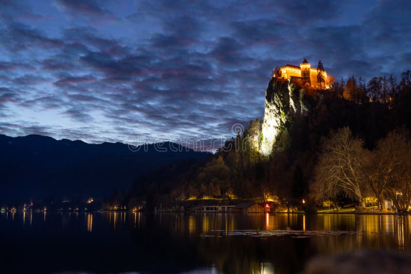 Dramatic Cloudscape Over Medieval Castle of Bled Perched on Cliff Above ...