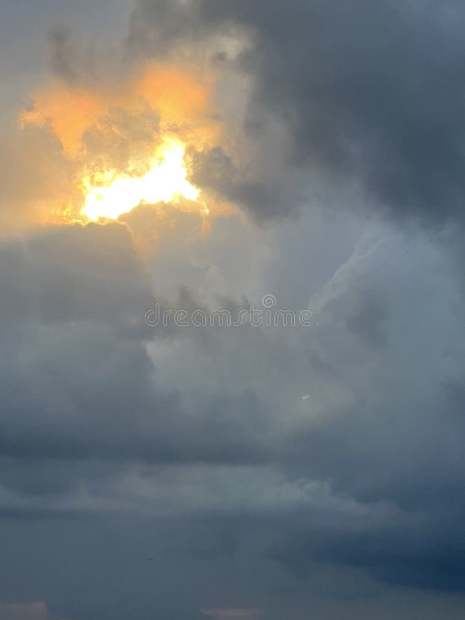 Dramatic Cloudy Sky with Glowing Sunlight Breaking through Dark Storm Clouds Stock Photo - Image ...
