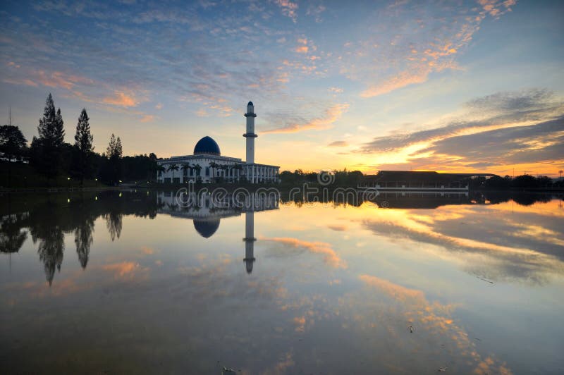 Dramatic Cloudy Sunrise Over White Floating Mosque. Stock Photo - Image ...