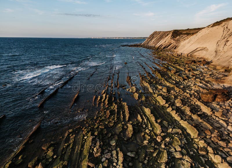 Dramatic Coastal Rock Formations with Layered Striations Stock Image ...