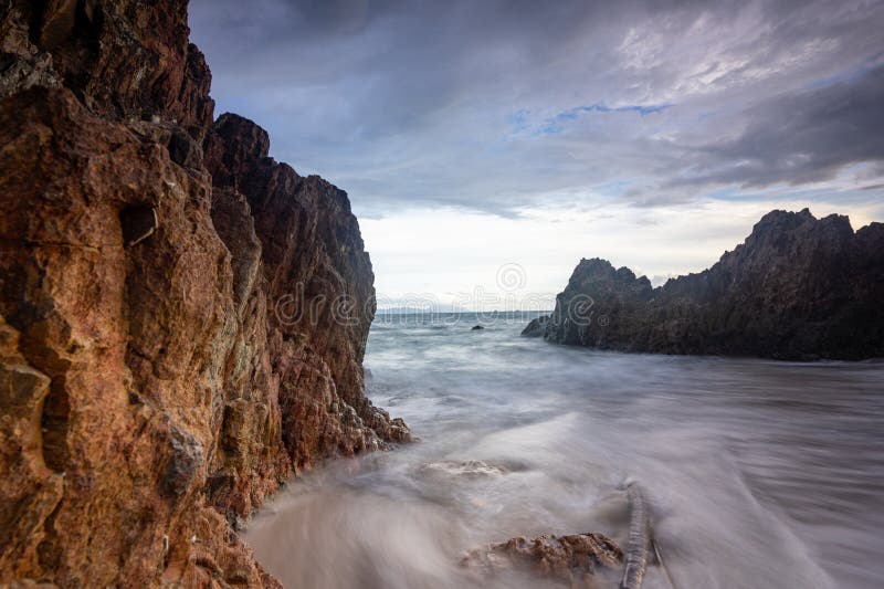 Dramatic Coastal Rocks, Motion Ocean Waves, Cloudy Sky Stock Photo ...