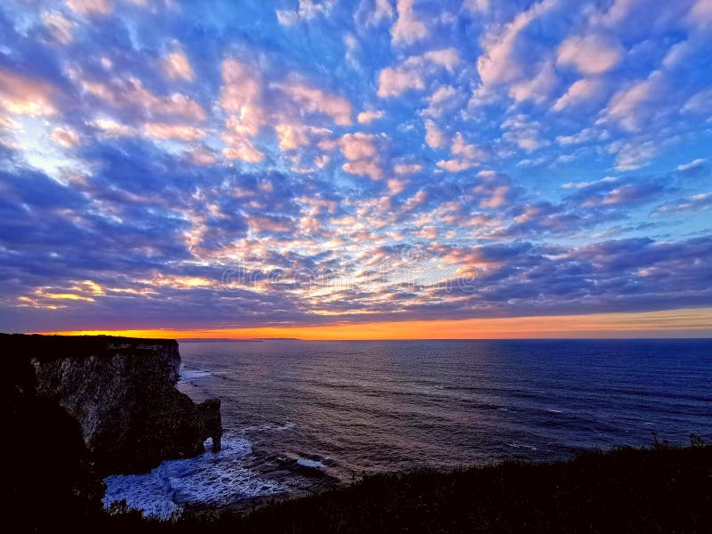 Dramatic coastal sunset stock image. Image of cliffs - 147012943
