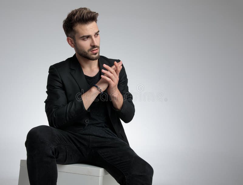 Dramatic Cool Guy Looking To Side and Rubbing Palms Stock Photo - Image ...